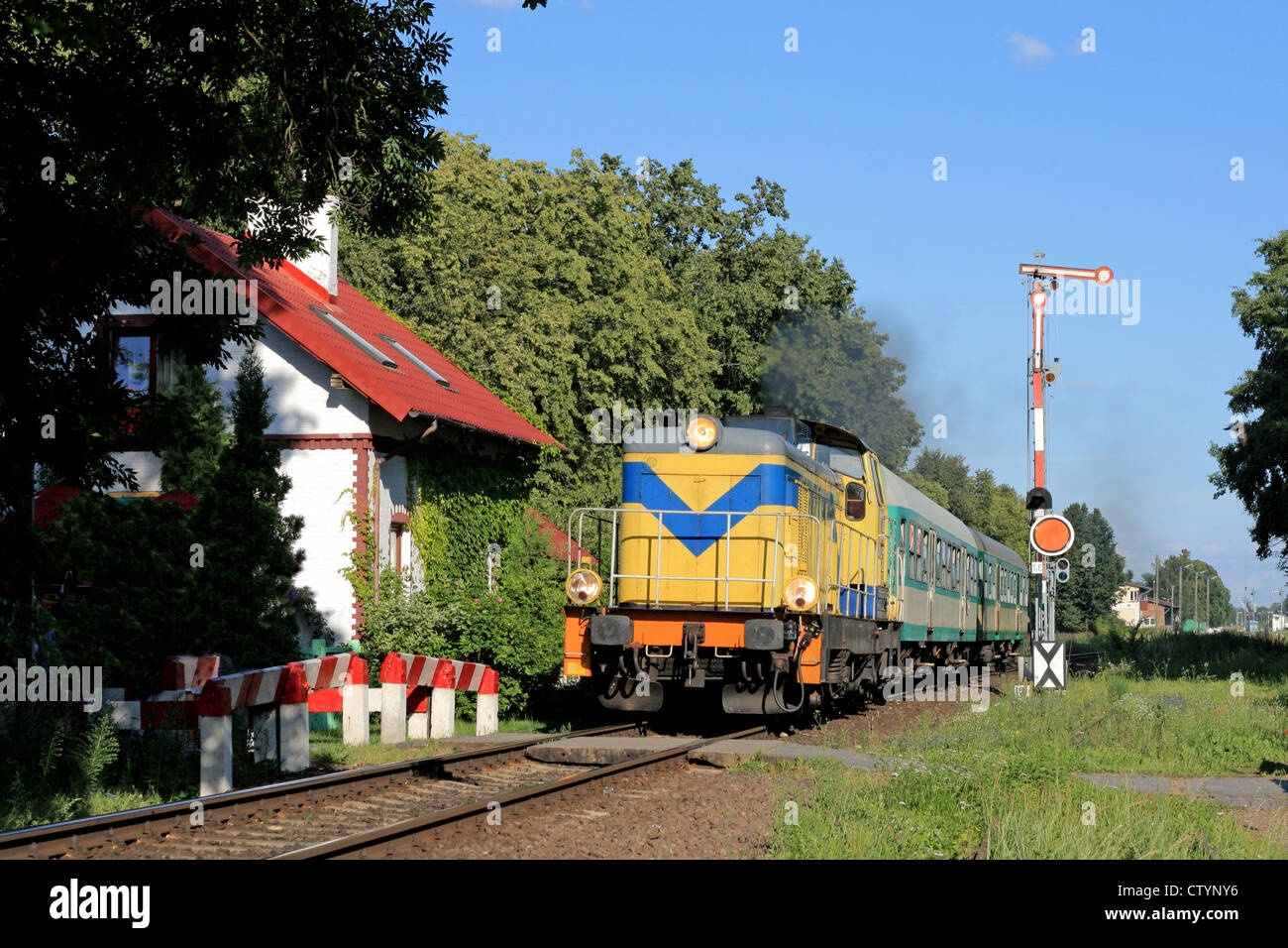 Passenger train starting from the station Stock Photo - Alamy