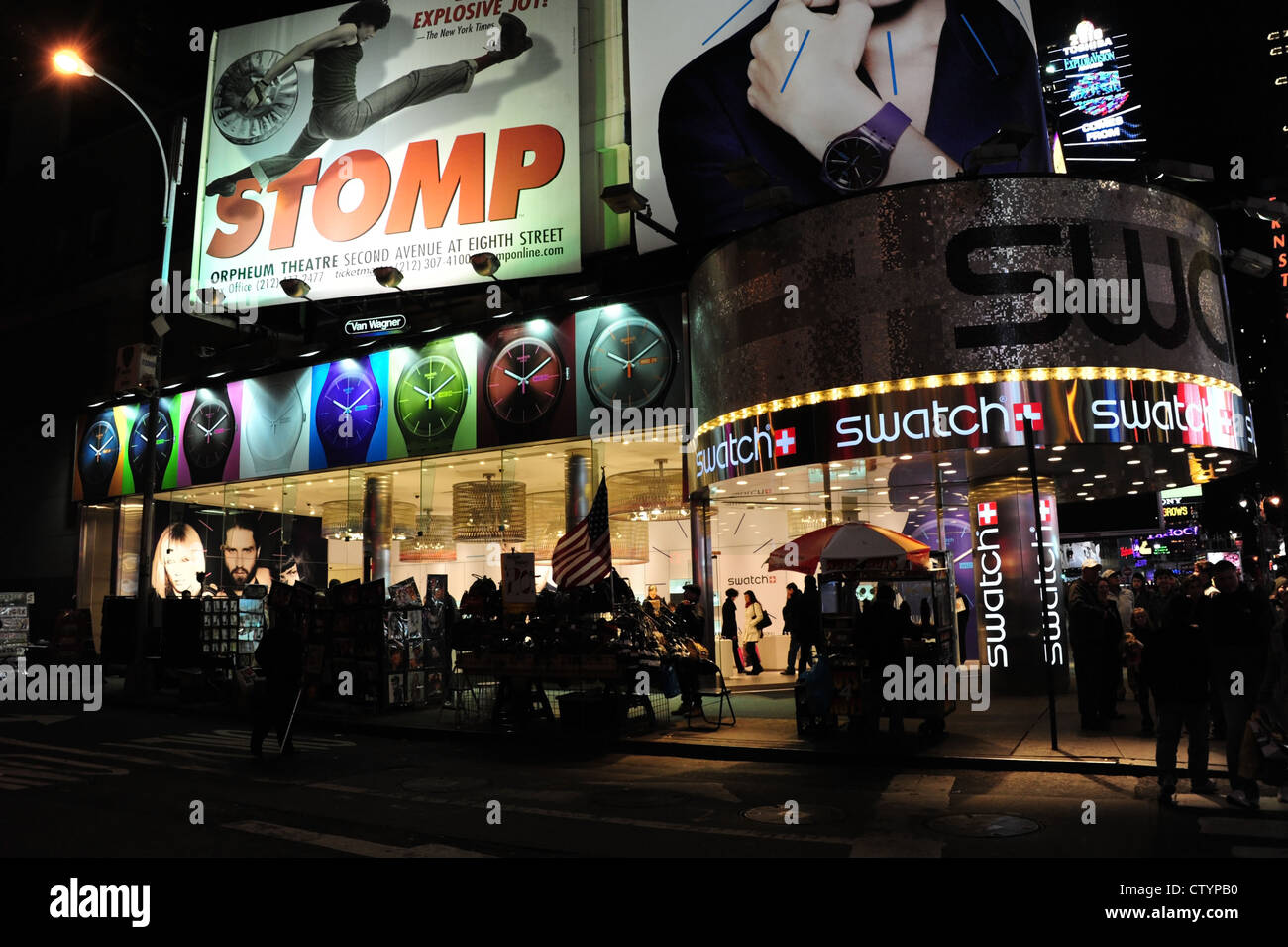 Night neon electric lights shop windows entrance Swatch Store, sidewalk ...