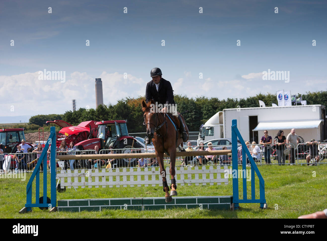 Show jumping clearing fence Stock Photo - Alamy