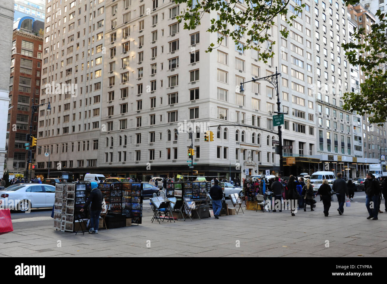 Three sidewalk stalls selling paintings souvenirs hats clothes, West ...