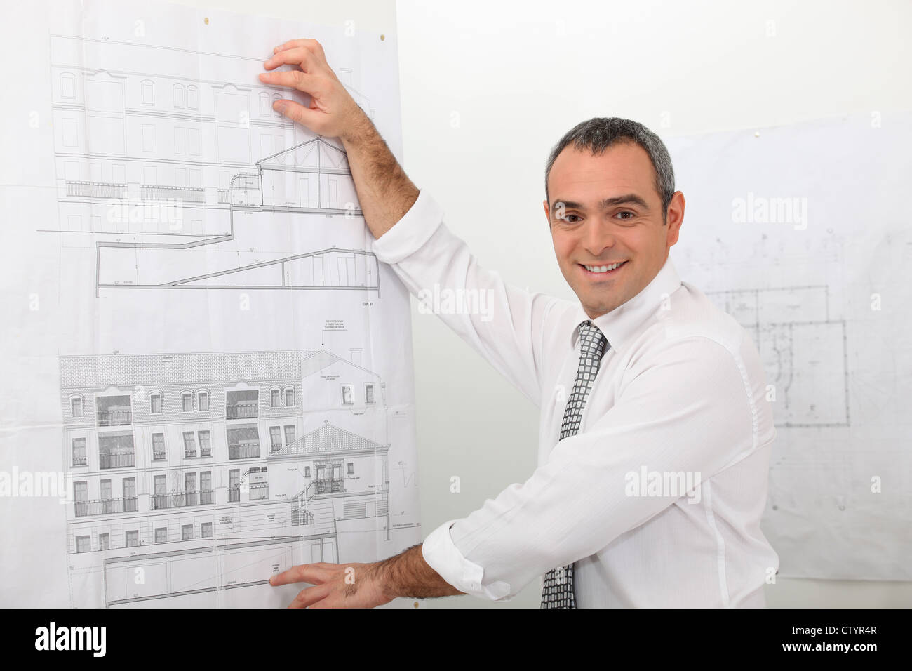 Smiling architect presenting project Stock Photo - Alamy