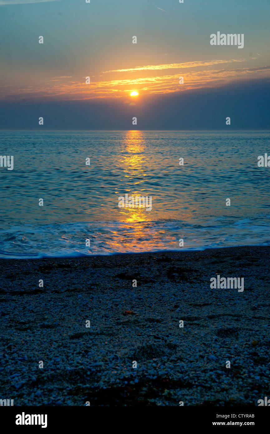 Beautiful skies of the atmospheric beach at sunset in Gunwalloe ...