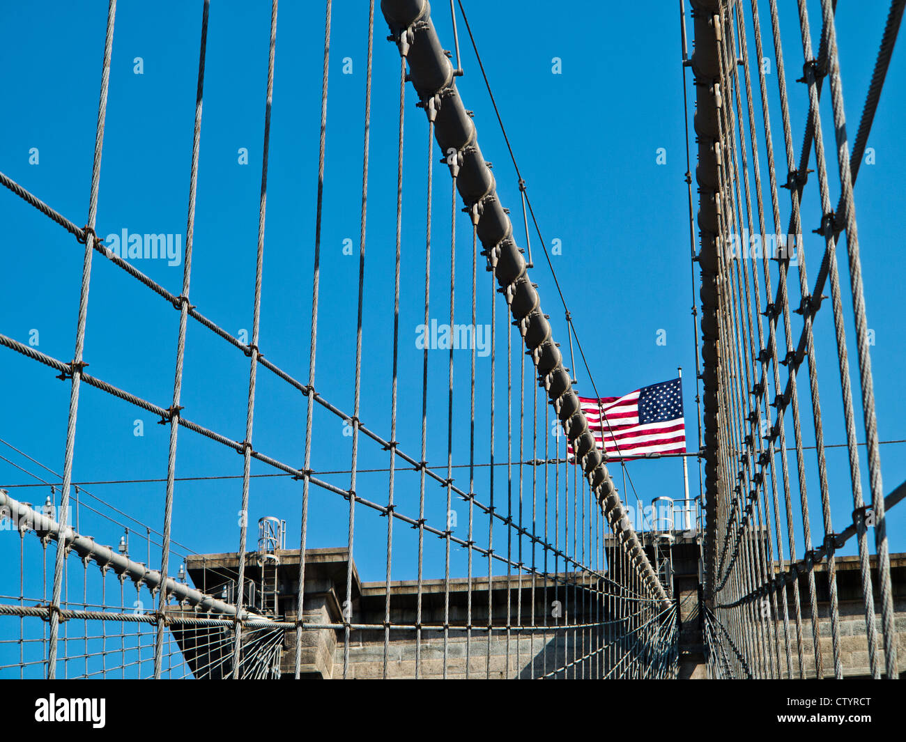 The American Flag flies above the Brooklyn Bridge. New York, New York ...
