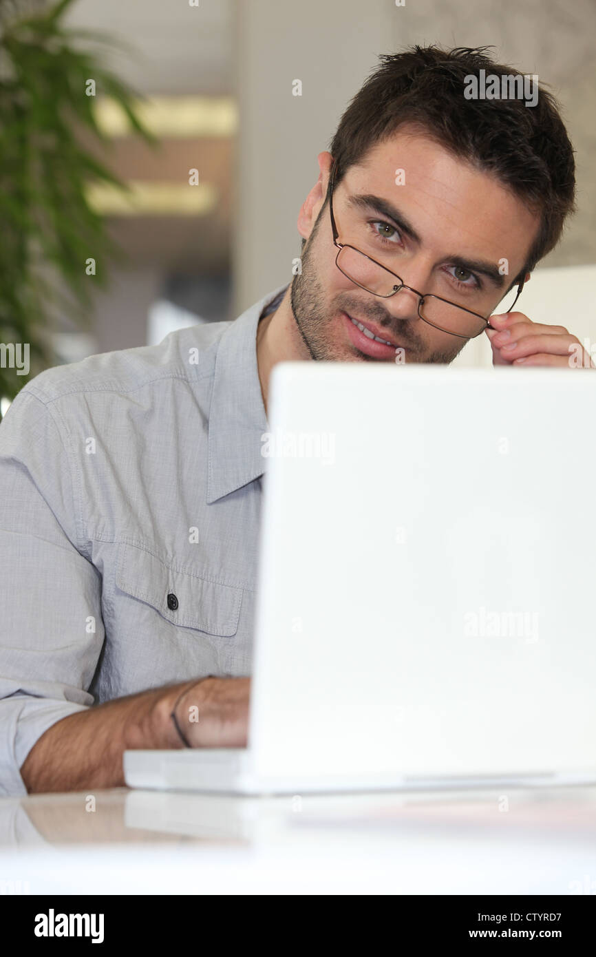 Man with glasses in front of computer Stock Photo - Alamy