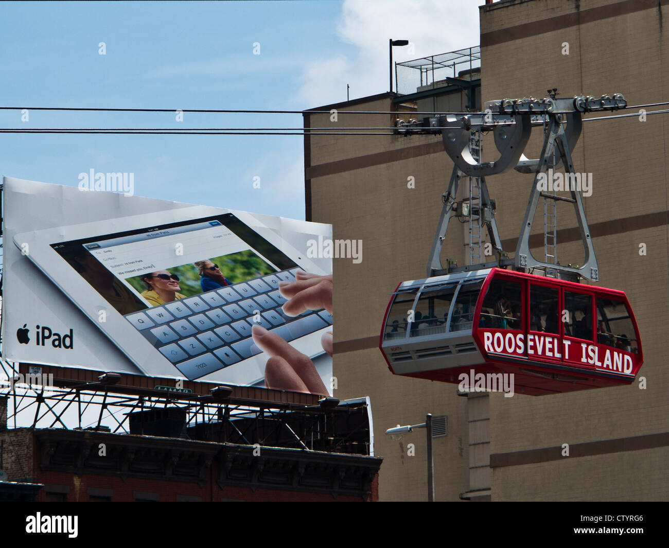 Roosevelt Island cable car passes by an iPad advertisement. New York ...