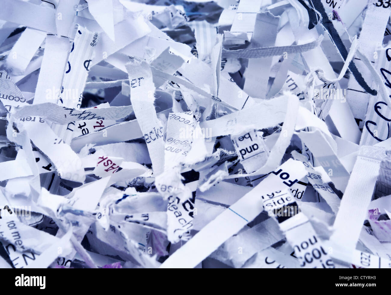 Close up of textured heap of shredded confidential papers with blue ...