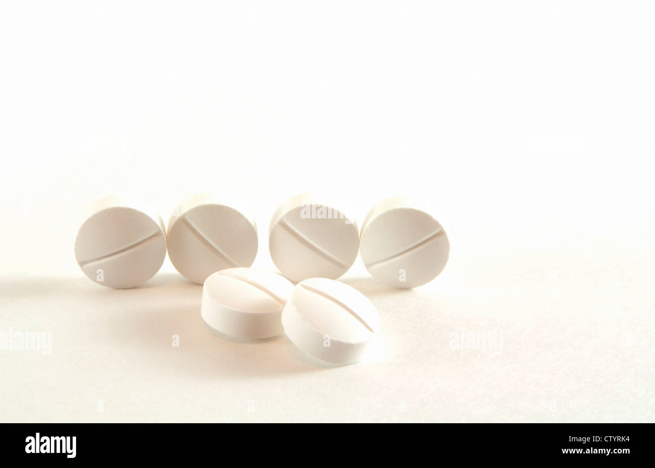 Six white medicinal pills or tablets isolated on white background with ...