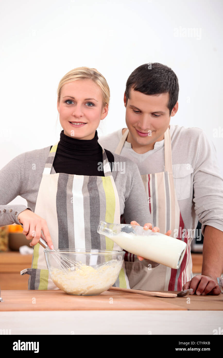 Couple baking together Stock Photo - Alamy