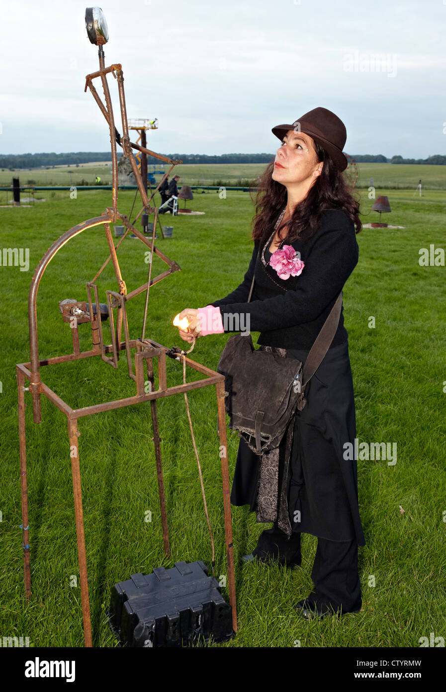Woman Lighting The Fire Garden Stonehenge UK Stock Photo - Alamy