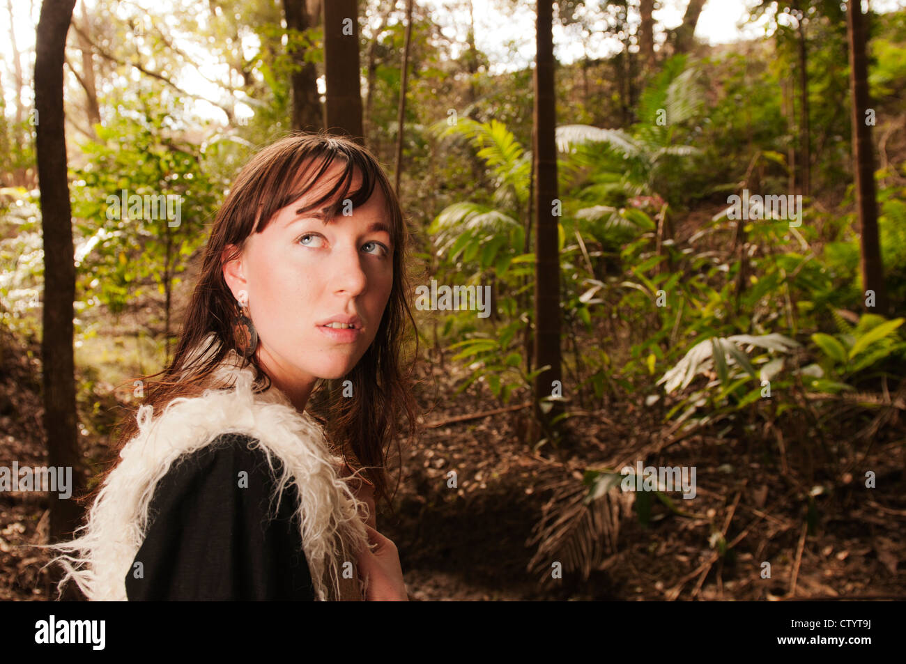 Young woman looking up while outdoors in rainforest setting Stock Photo ...