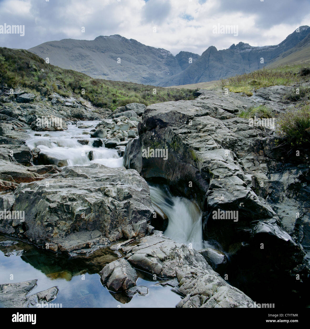 A fast-flowing river cuts through a rock channel in Glen Brittle, Isle ...