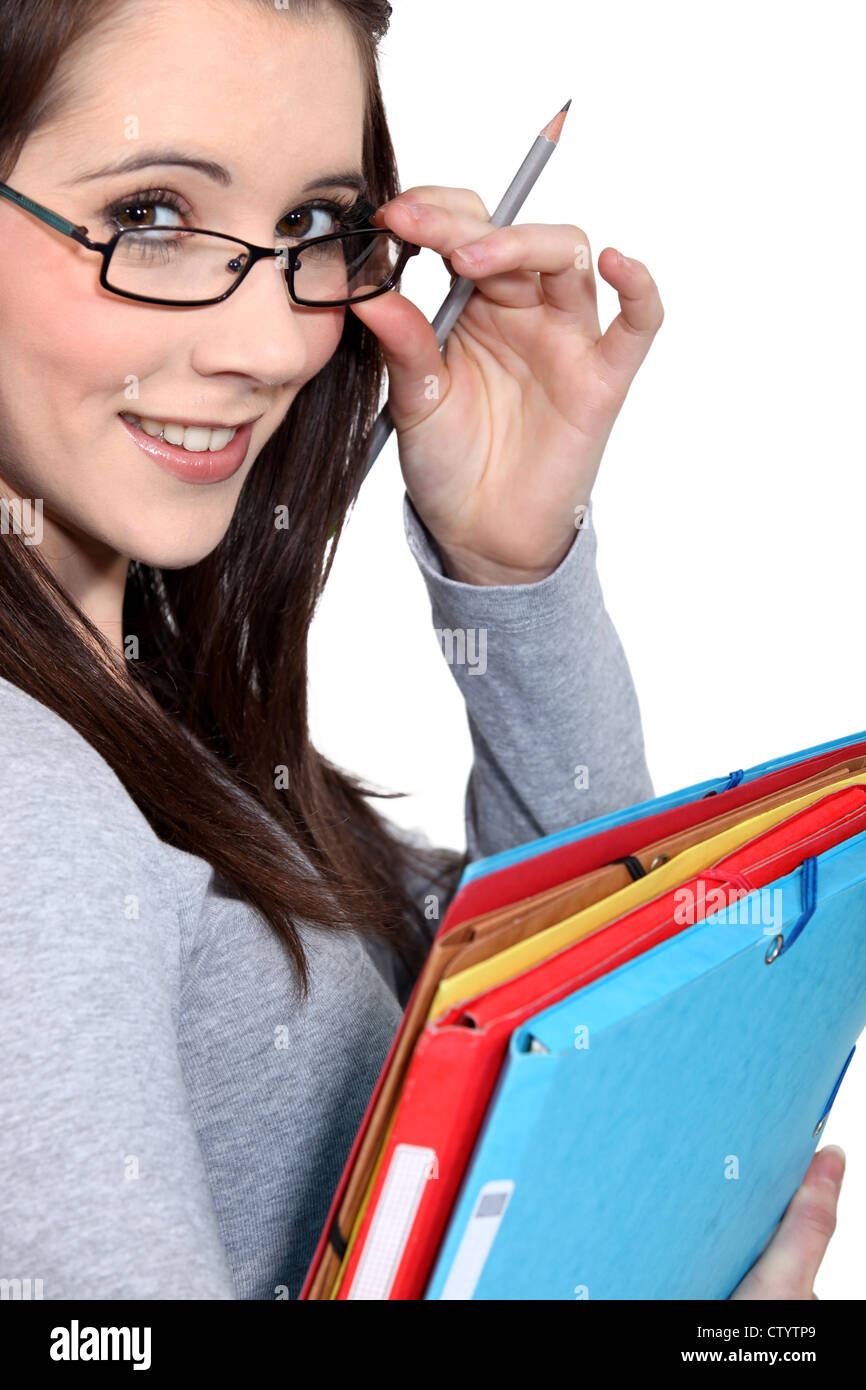 portrait of female student with glasses lowered holding files Stock ...