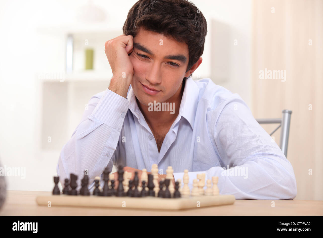Young man playing chess Stock Photo - Alamy