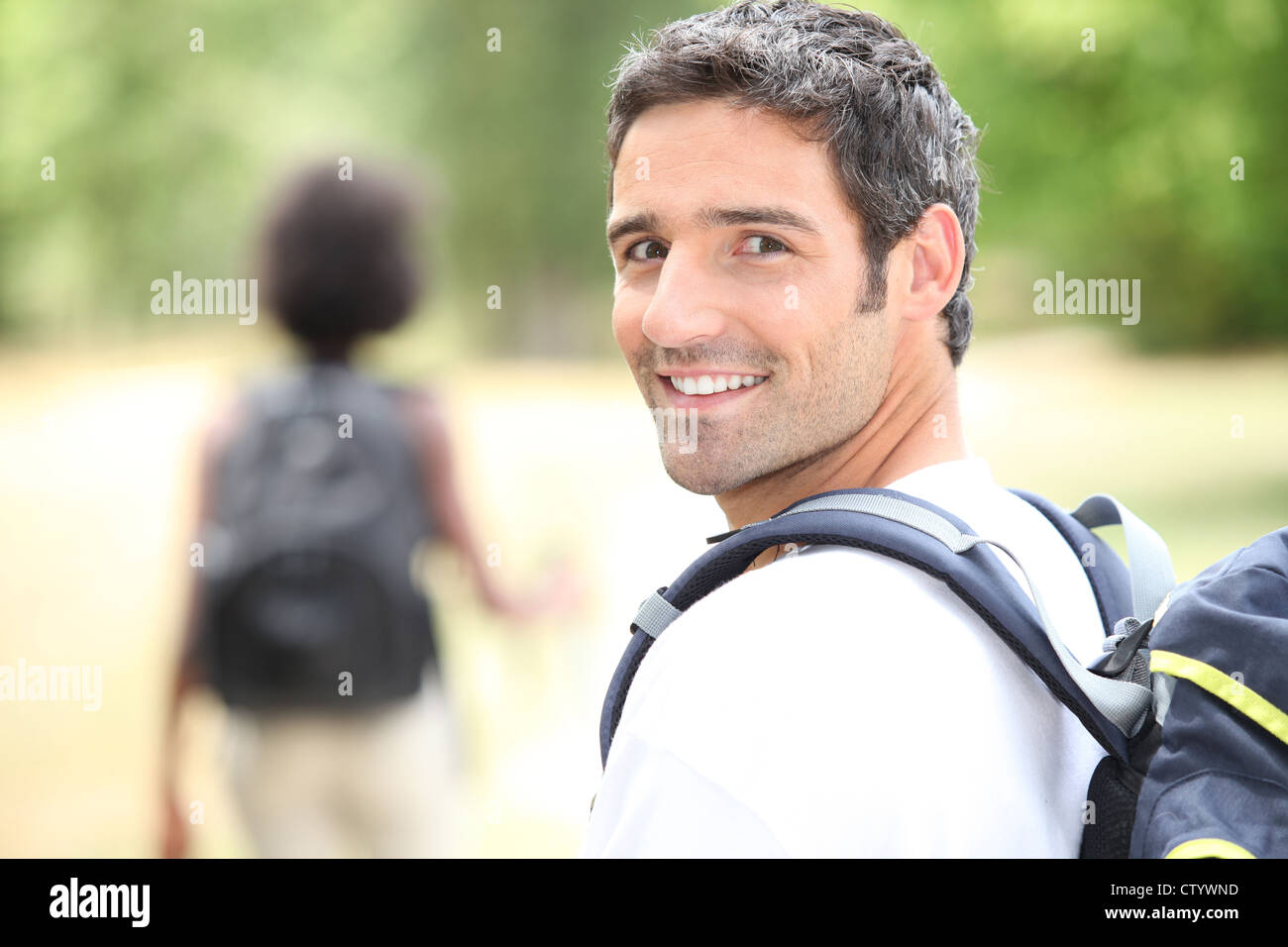 Couple walking through the countryside Stock Photo - Alamy