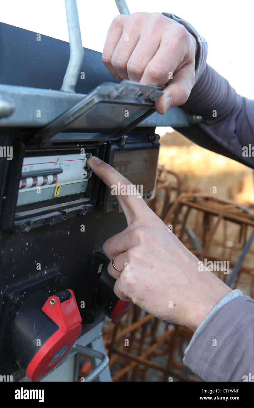 man turning on the fuse box Stock Photo - Alamy