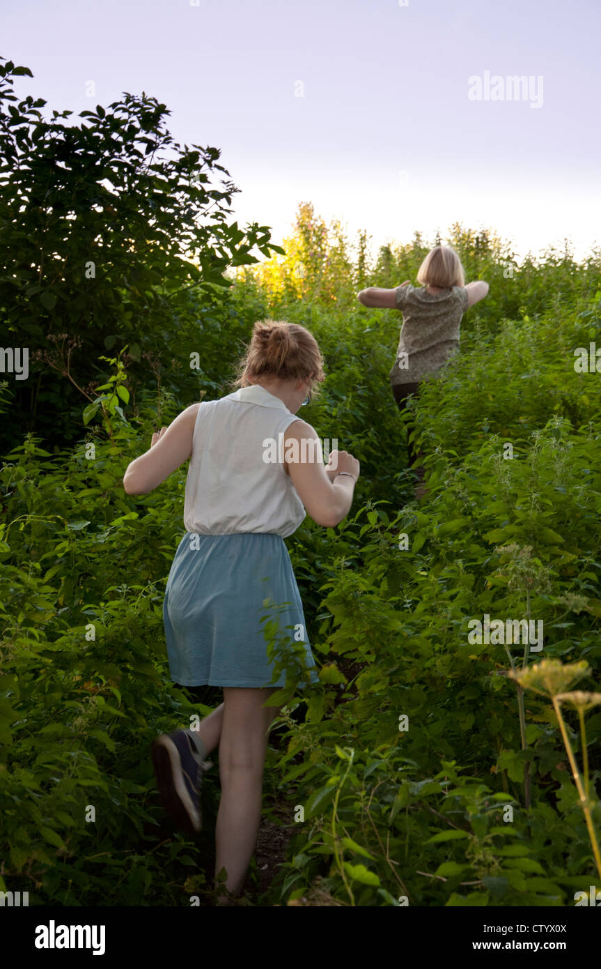 girl walking through stinging nettles Stock Photo - Alamy