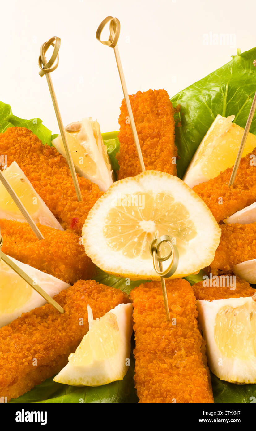 Crunchy fish starter served with salad and lemon Stock Photo - Alamy