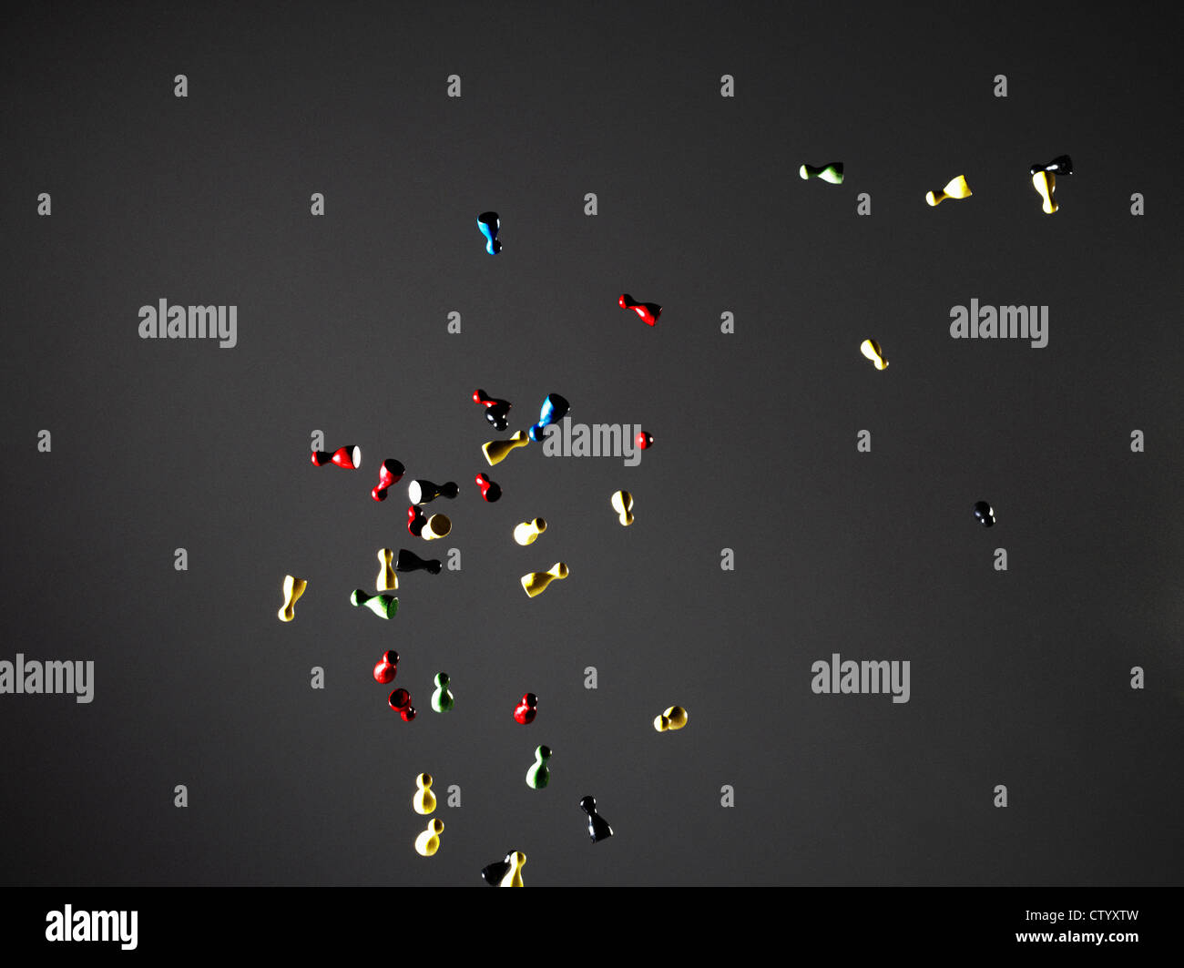 Colorful game pieces flying in air Stock Photo - Alamy
