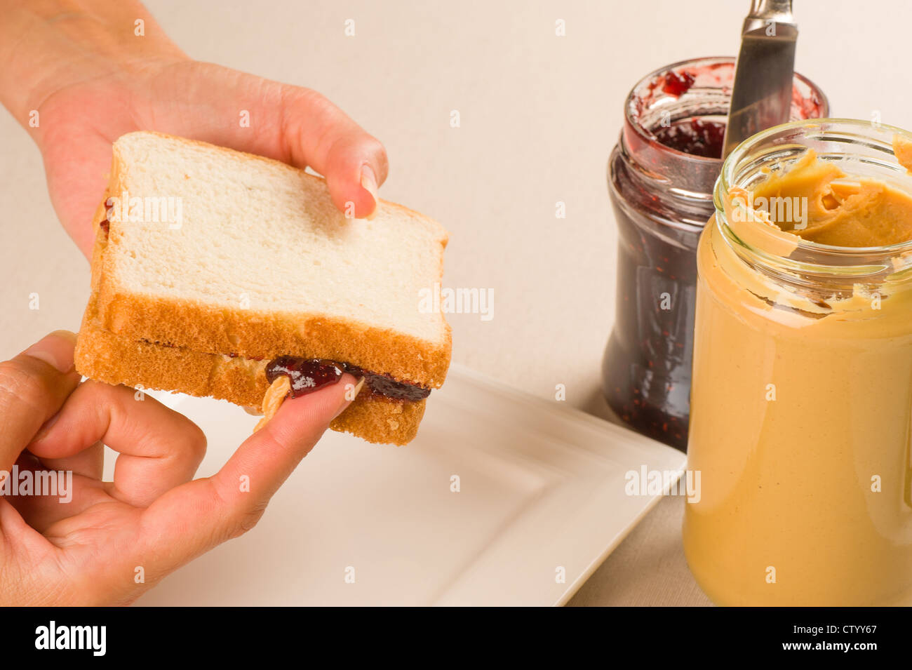 Dripping raspberry jam and peanut butter sandwich Stock Photo - Alamy