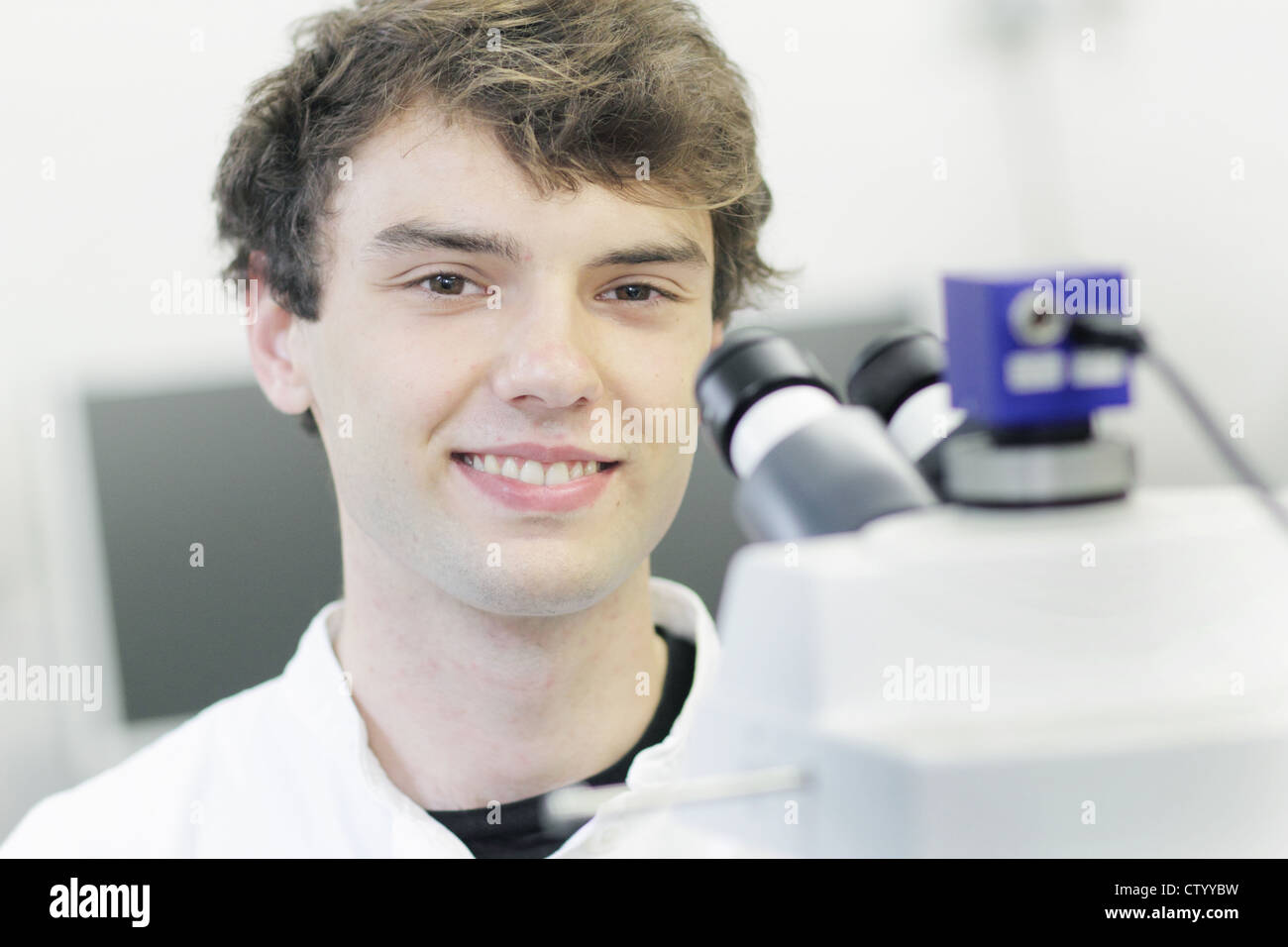 Scientist standing at microscope in lab Stock Photo - Alamy