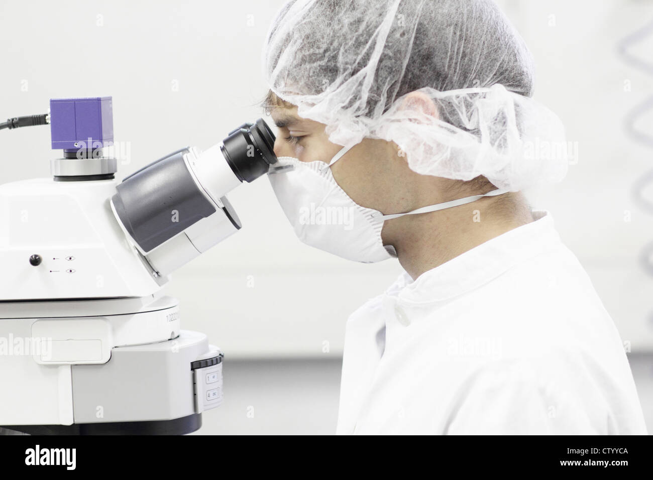 Scientist using microscope in lab Stock Photo - Alamy
