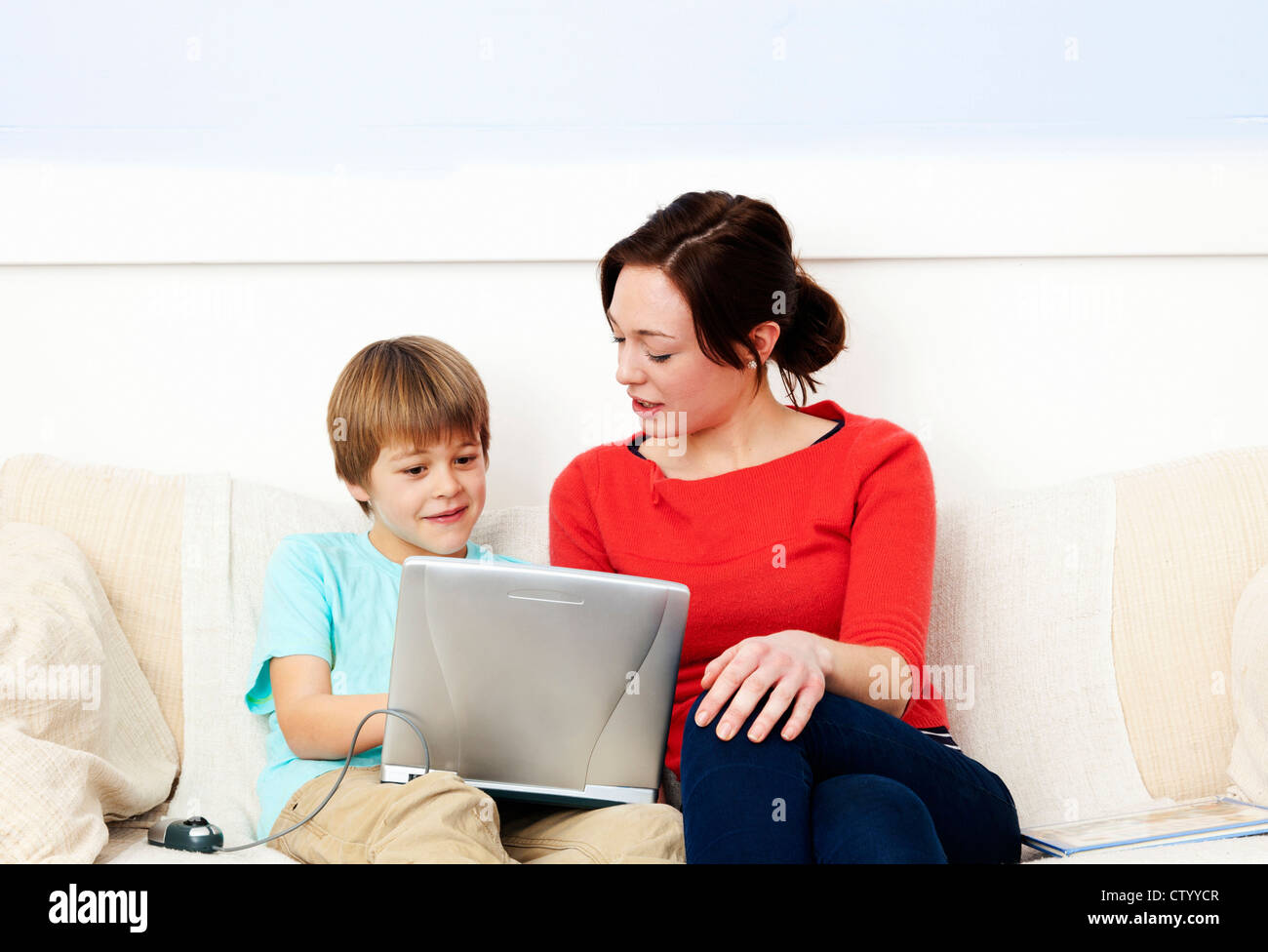 Mother and son using laptop together Stock Photo - Alamy