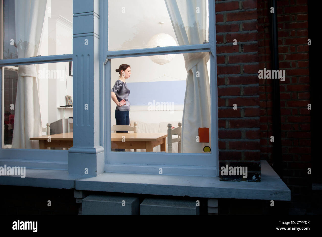 Woman viewed through window Stock Photo - Alamy