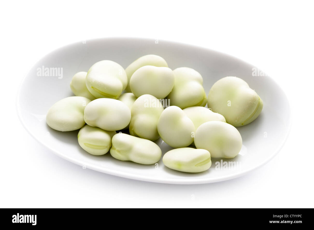 shelled broad beans or fava beans in a white dish isolated Stock Photo ...