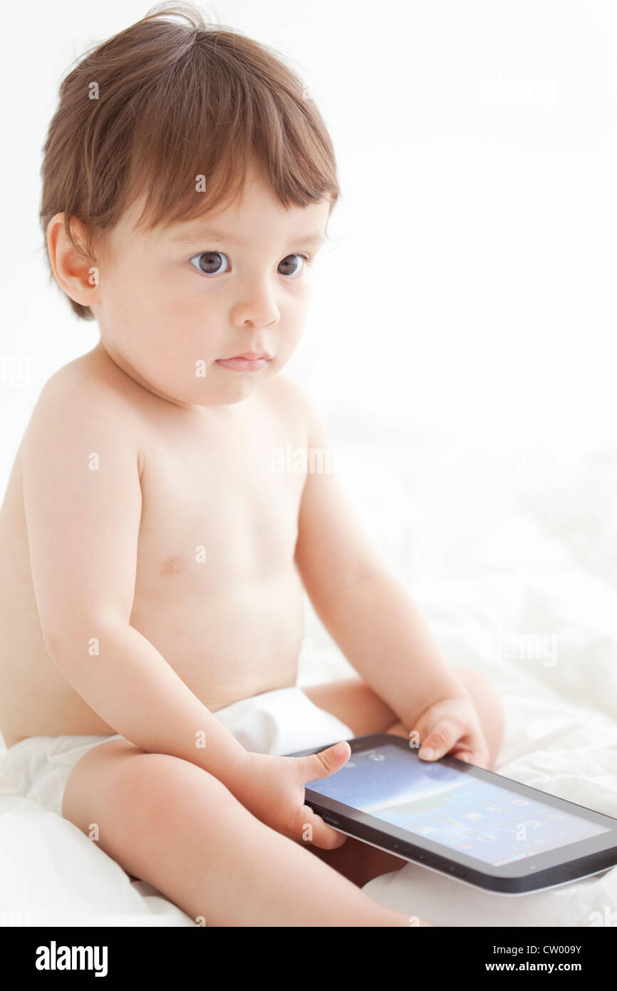 Baby boy holding Tablet PC Stock Photo - Alamy