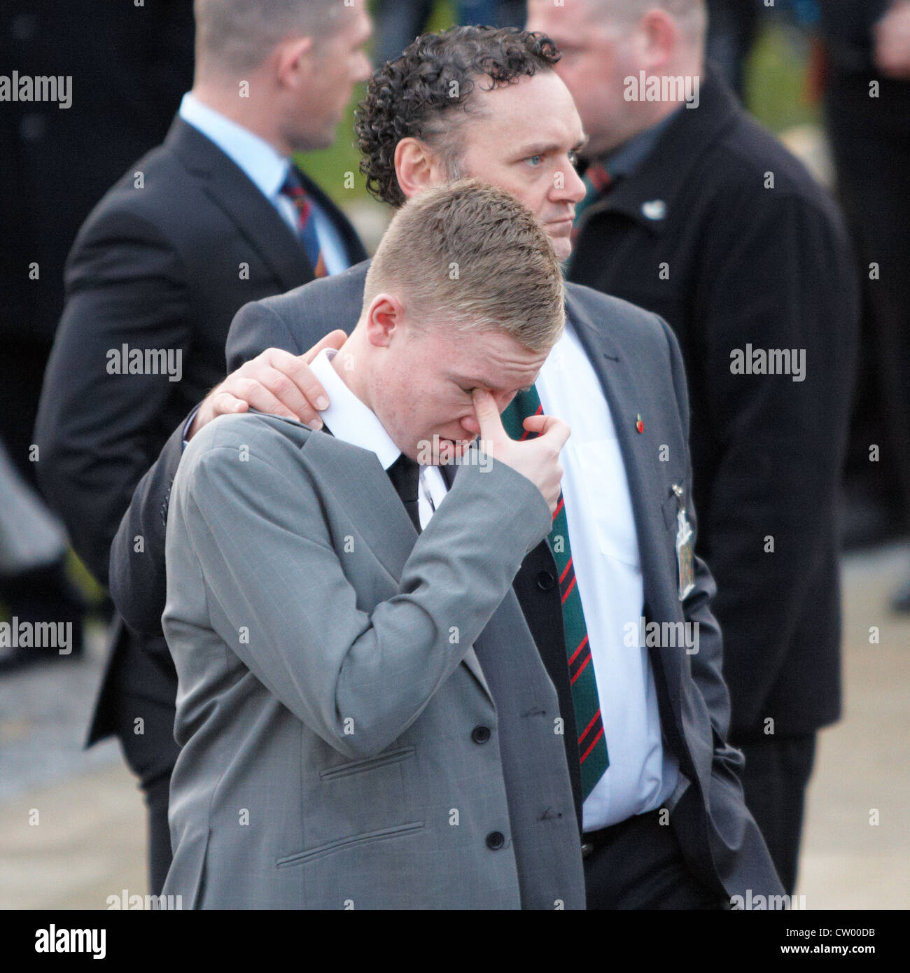 Friends, family & colleagues of L/Cpl Peter Eustace react during a ...