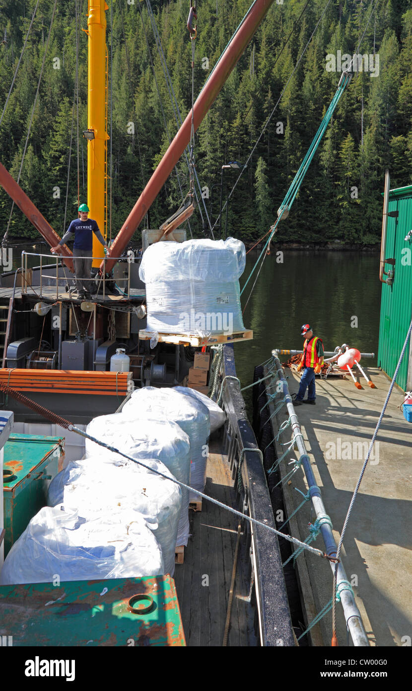 Operating the dual-control winch to unload fish food from the MV Uchuck ...