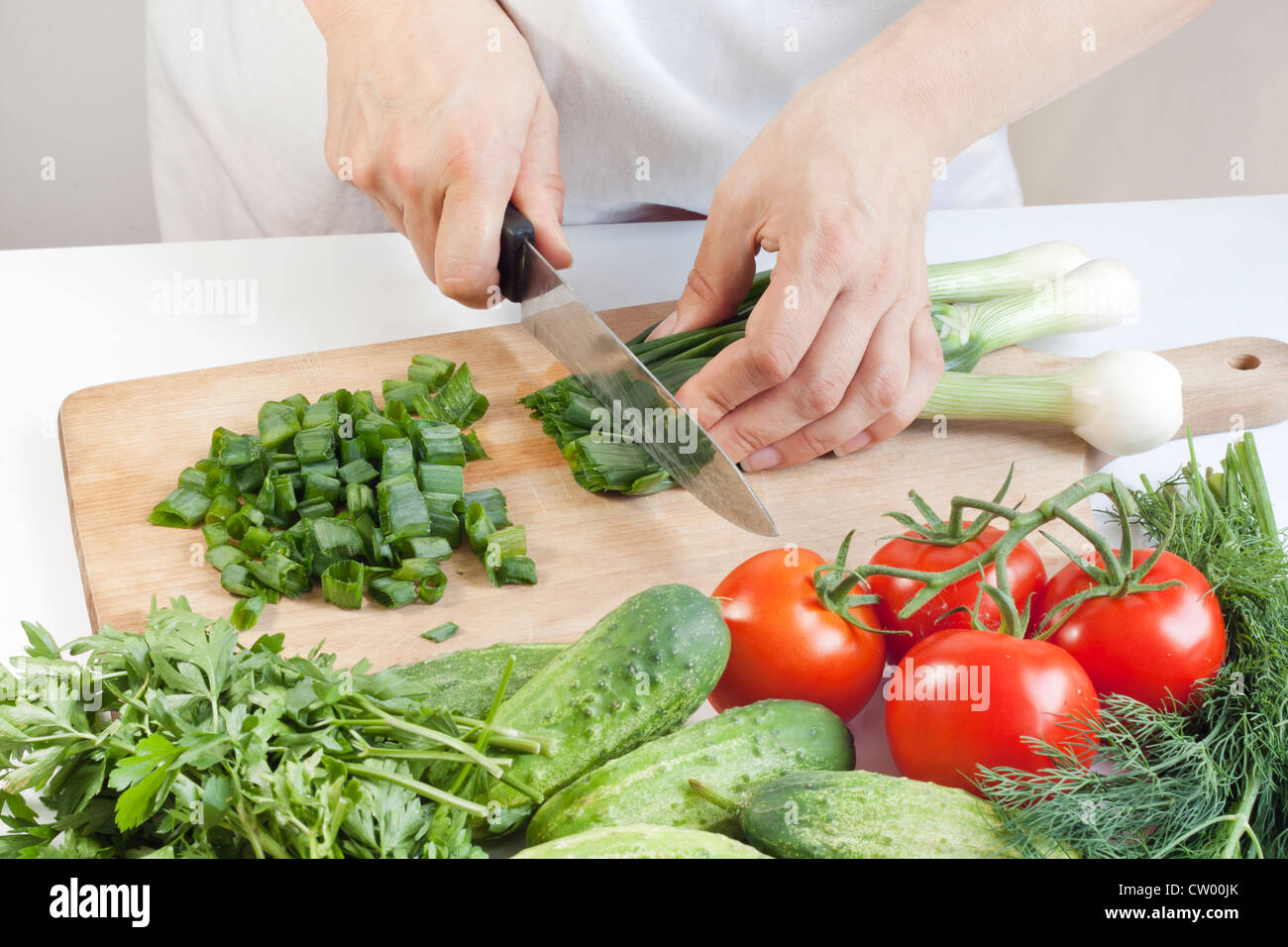 Cook in the kitchen at work cutting vegetables Stock Photo - Alamy