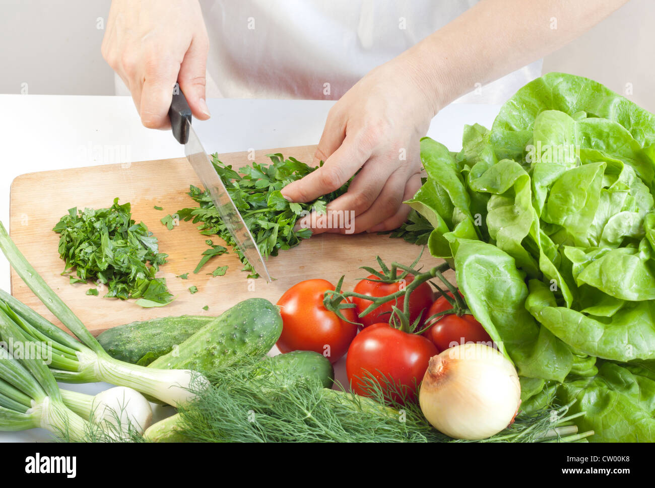 Cook in the kitchen at work cutting vegetables Stock Photo - Alamy