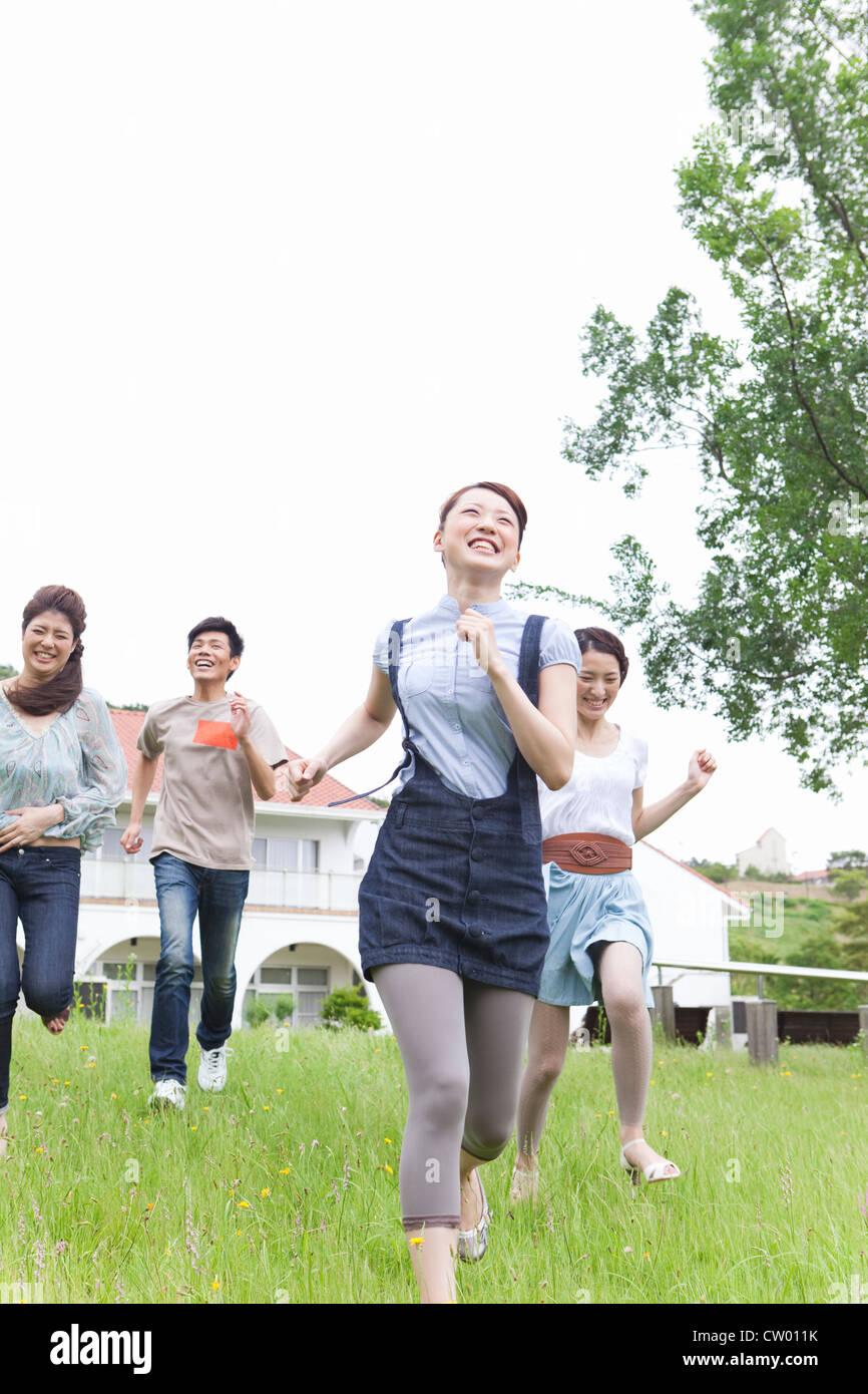 Four university students running Stock Photo - Alamy