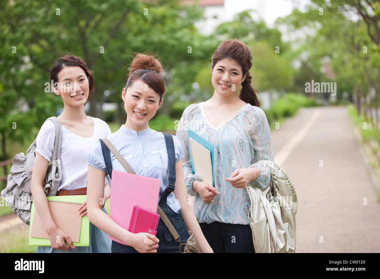 Three university students smiling Stock Photo - Alamy