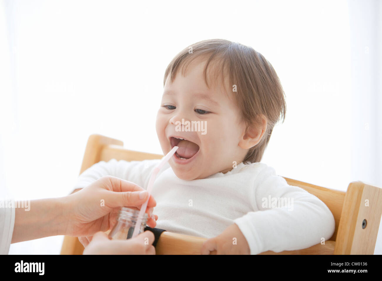 Baby boy drinking Stock Photo - Alamy