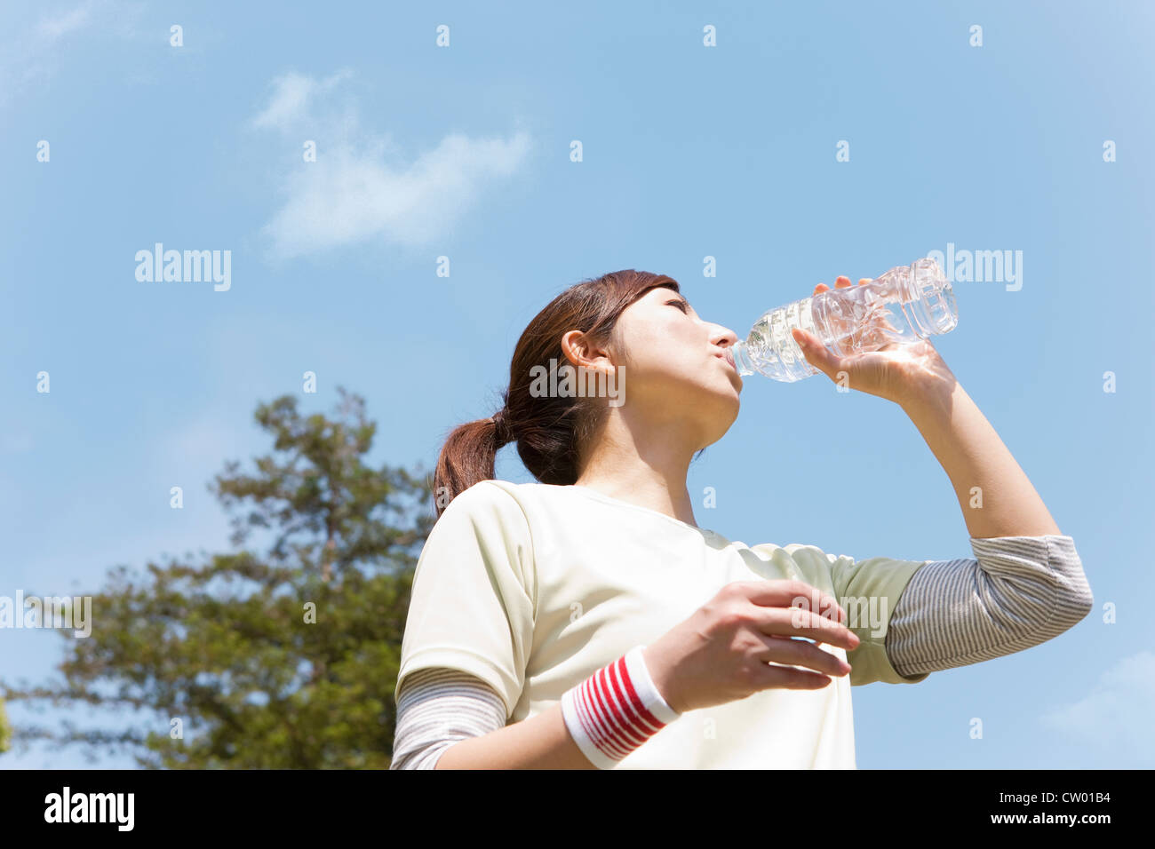 Young woman drinking water Stock Photo - Alamy