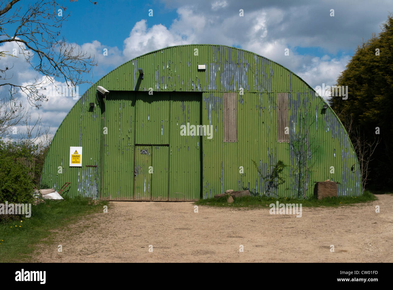 Large old green painted garage type corrugated iron building with ...