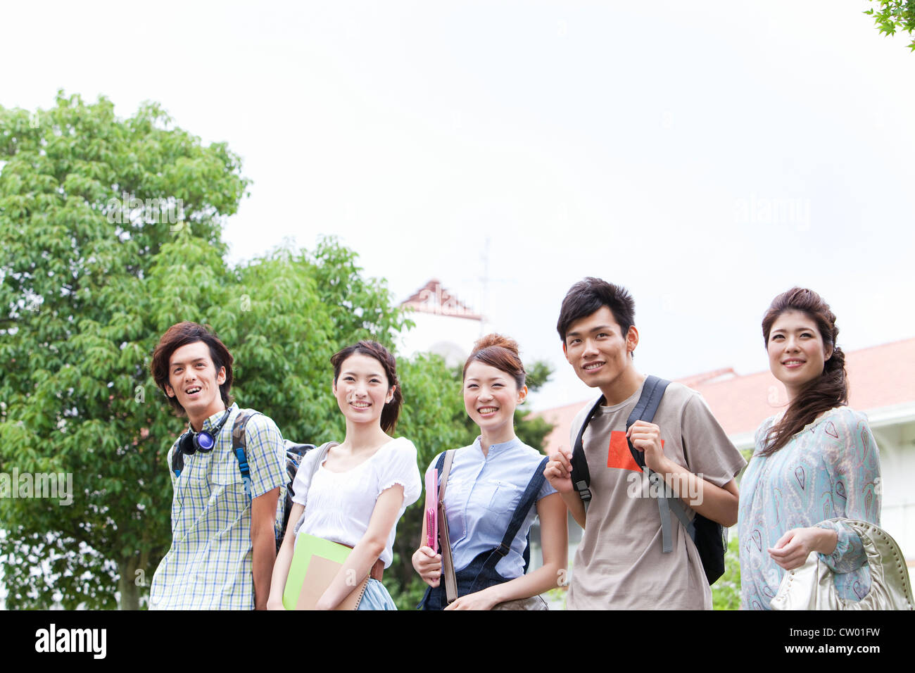 University students leaning on railing Stock Photo - Alamy