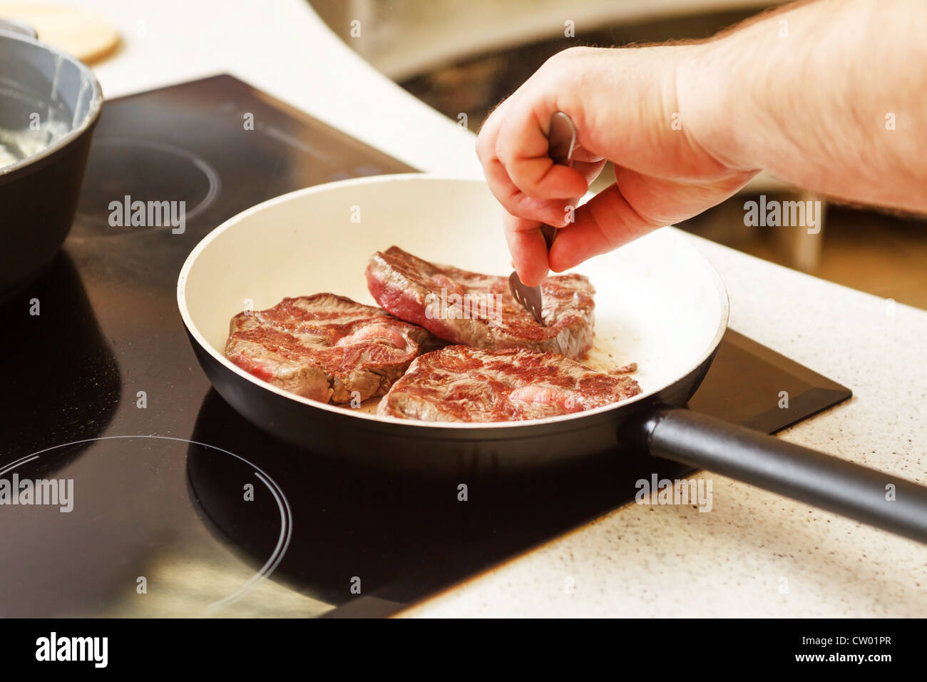 beef steak in a frying pan Stock Photo - Alamy