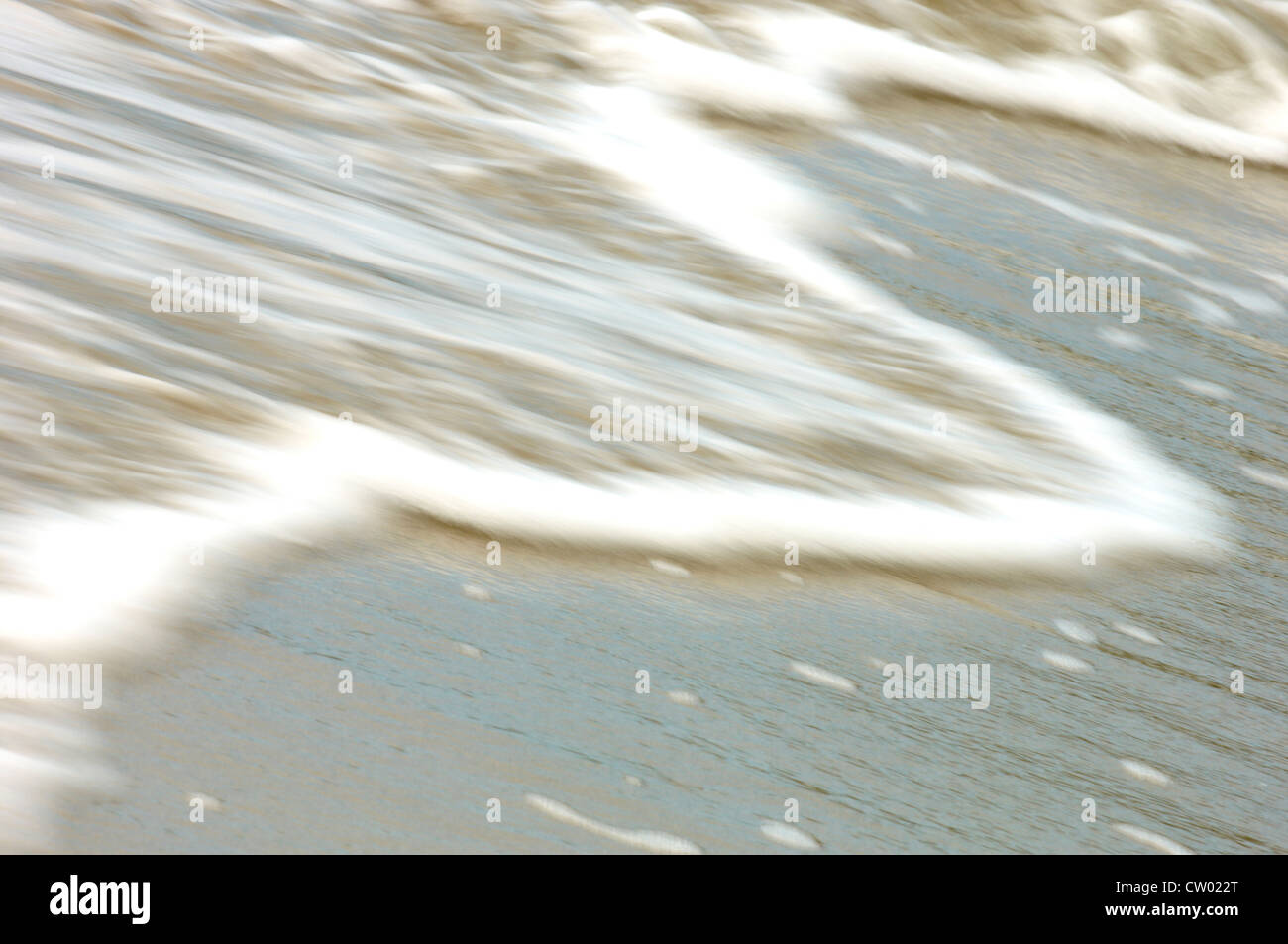 tropical beach scene showing waves lapping at the shore Stock Photo - Alamy