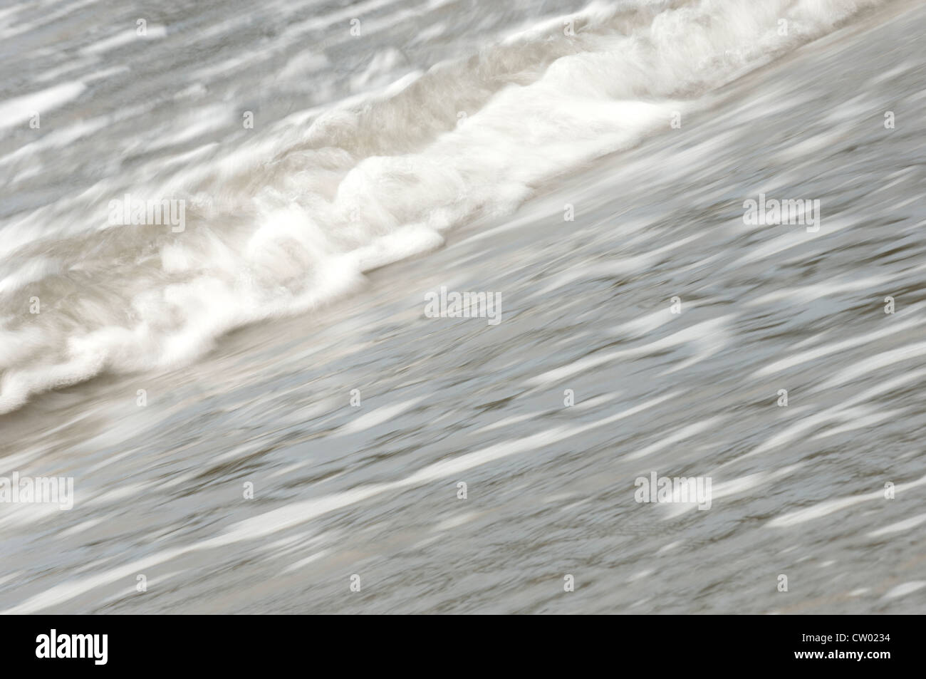 tropical beach scene showing waves lapping at the shore Stock Photo - Alamy