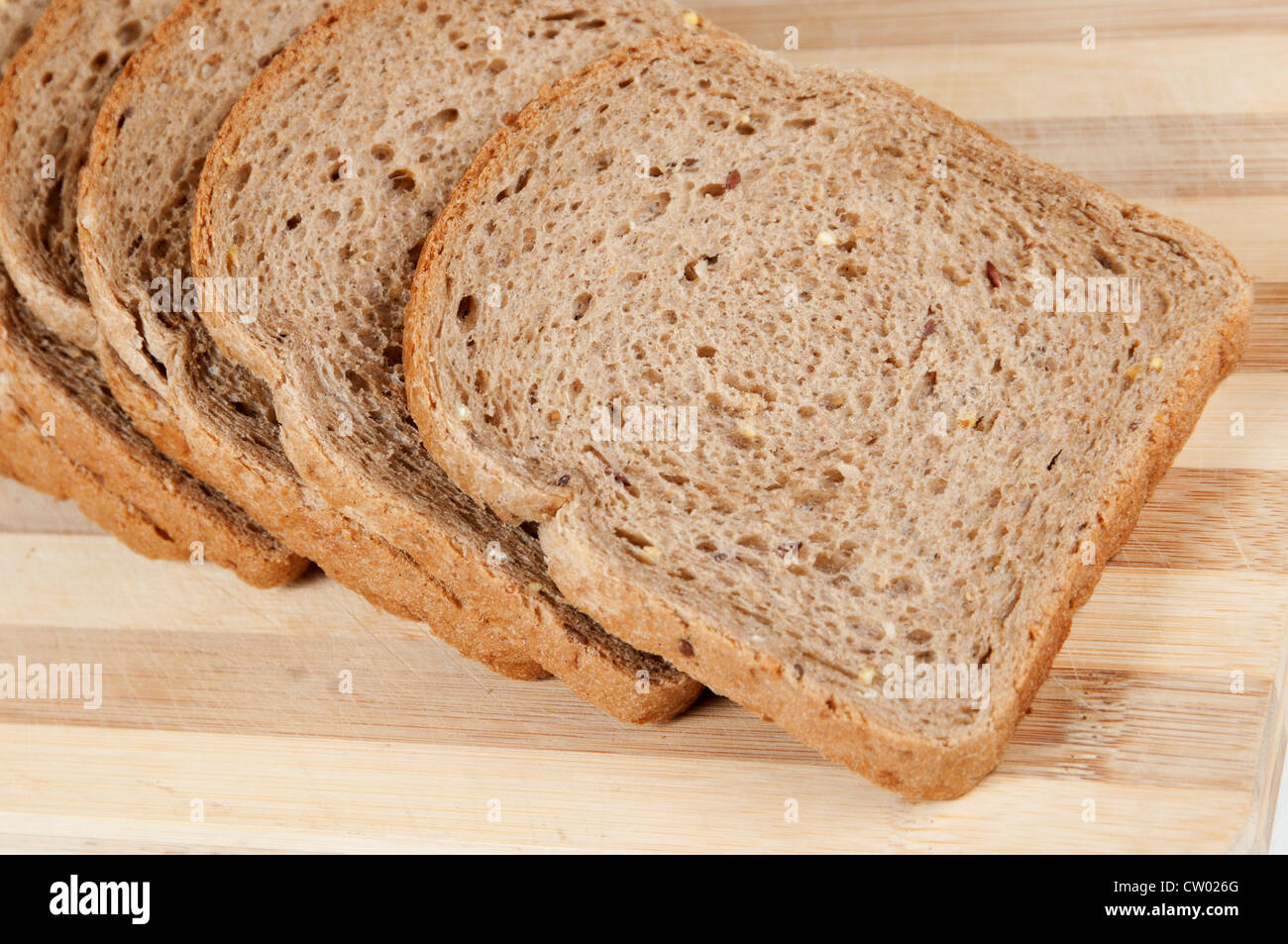 Pieces of grain bread on a board Stock Photo - Alamy