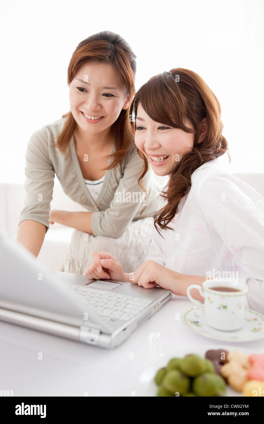 Two women using laptop Stock Photo - Alamy