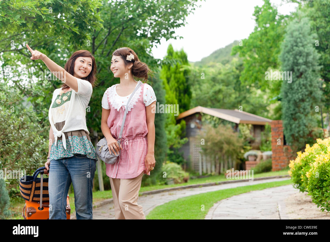 Young women talking and walking Stock Photo - Alamy
