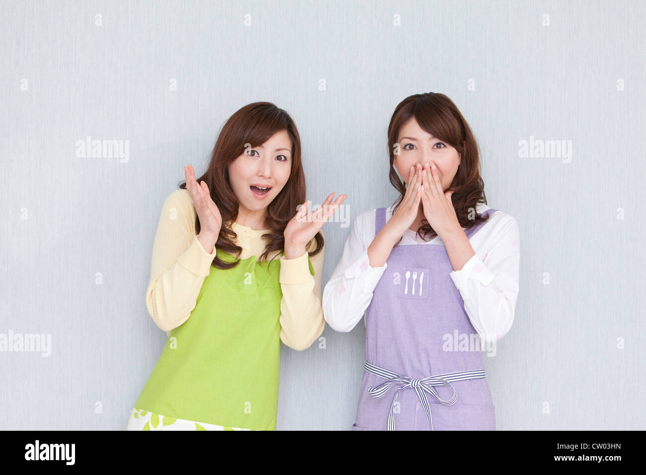 Two women looking surprised Stock Photo - Alamy