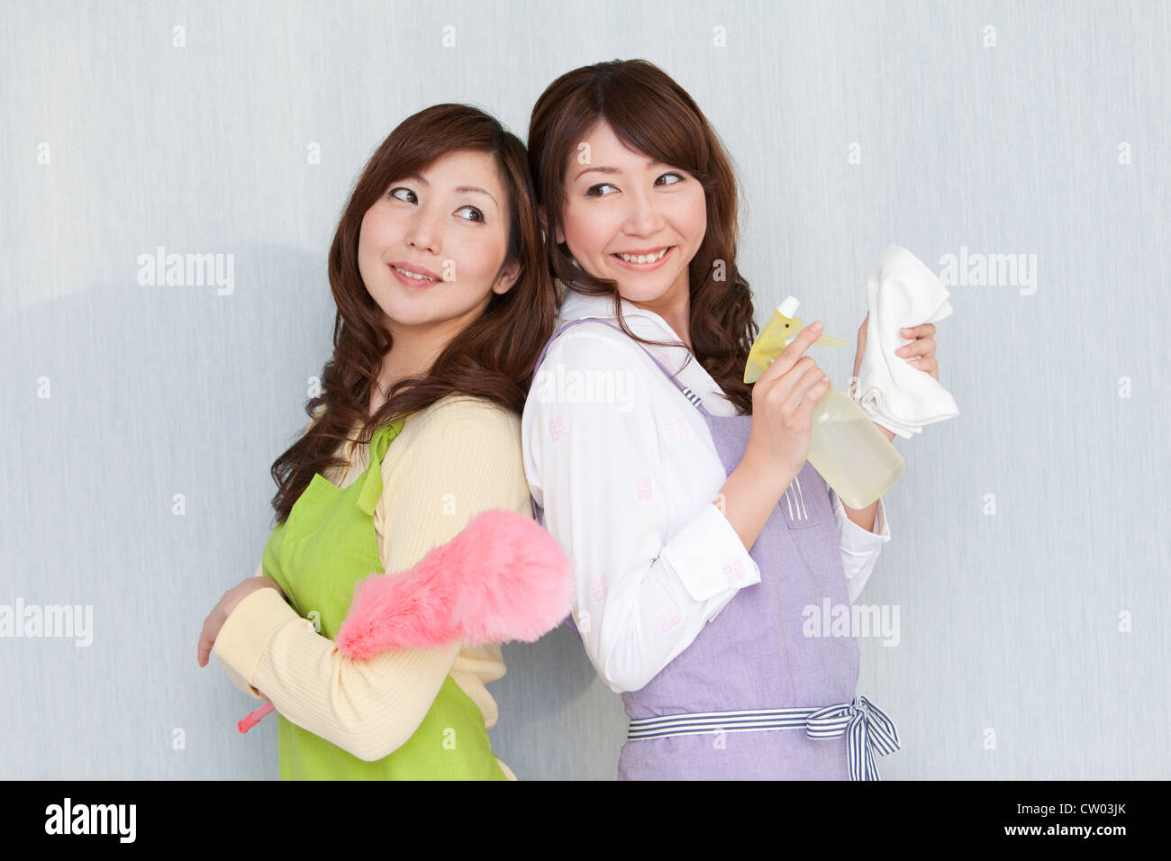 Two women with cleaning products Stock Photo - Alamy