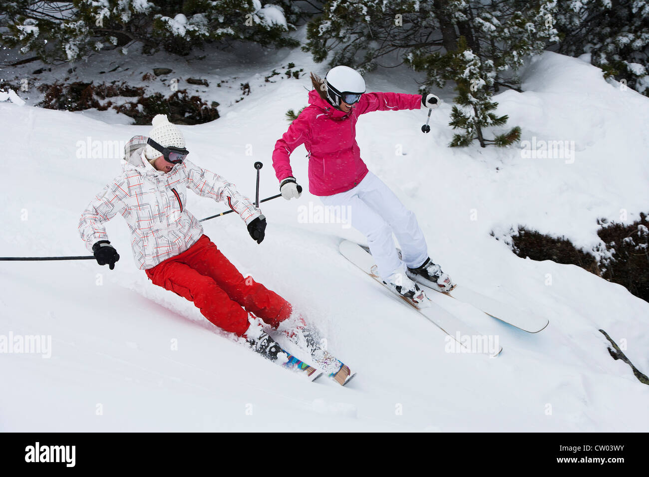 Skiers coasting on snowy slope Stock Photo - Alamy