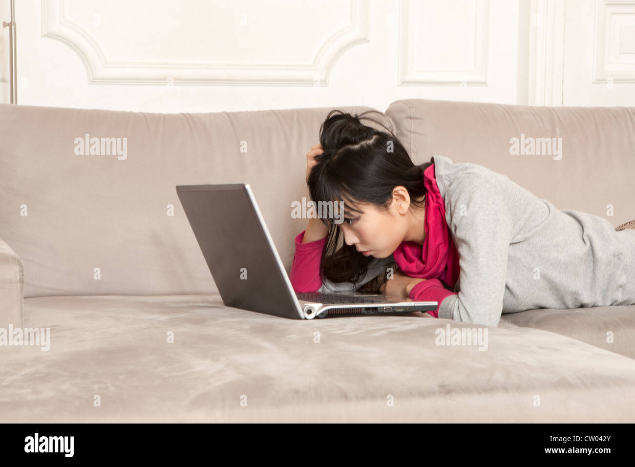 Woman Lying On Couch With Laptop High Resolution Stock Photography and ...