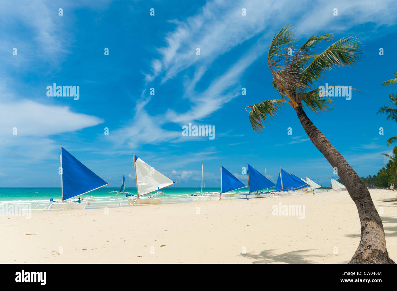 traditional paraw sailing boats on white beach on boracay island ...